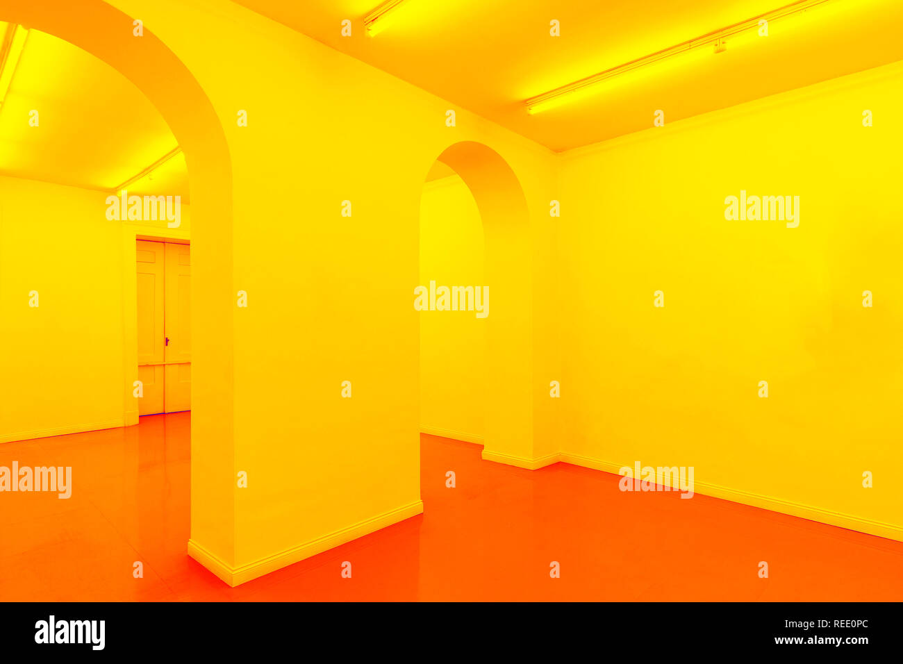 A yellow and orange empty room interior Stock Photo - Alamy