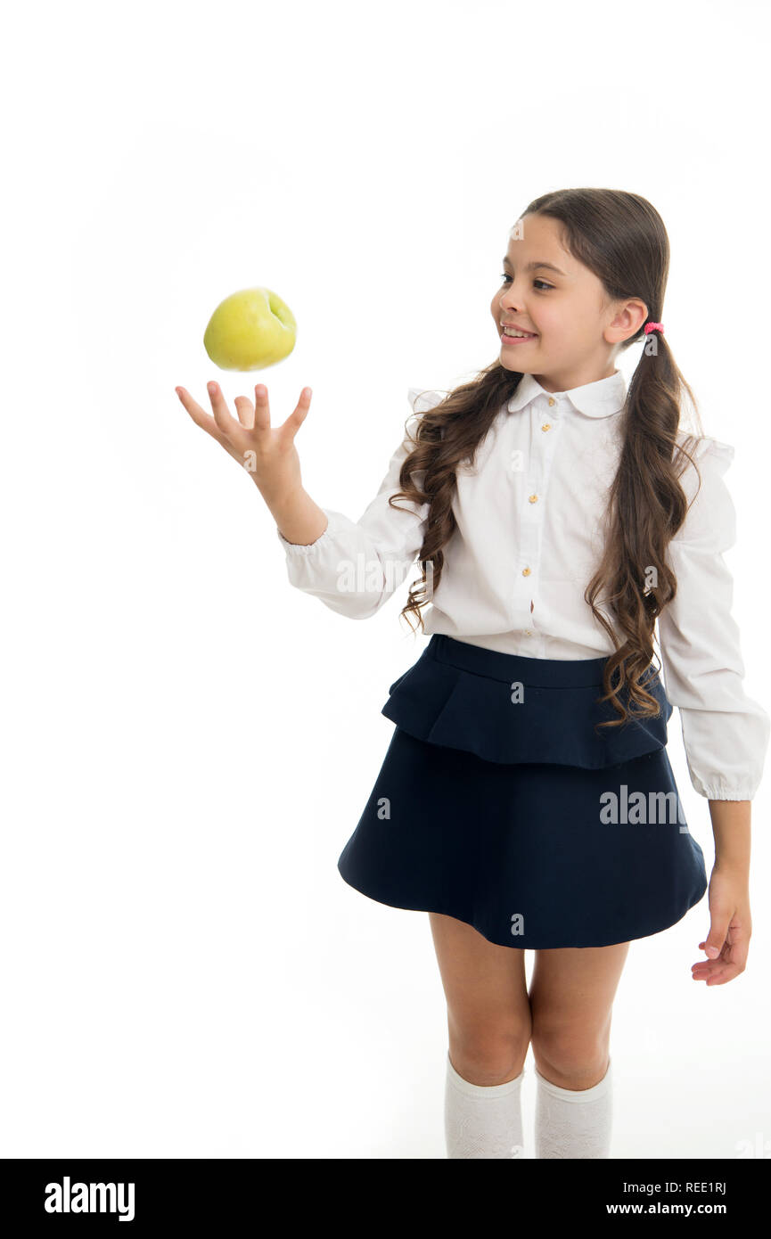 Child girl school uniform clothes toss apple. Girl cute pupil holds ...