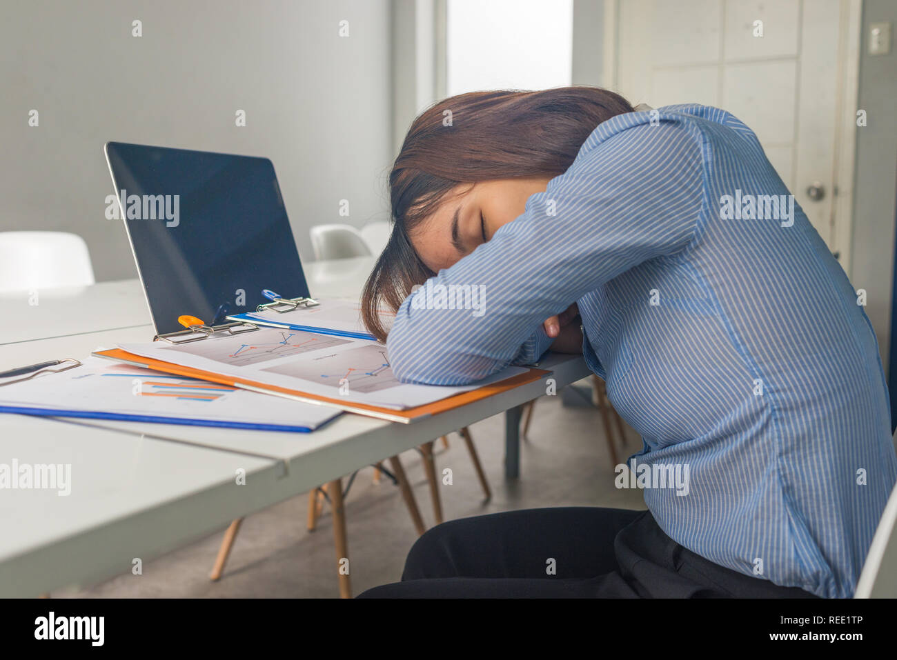 Tired businesswoman accountant sleeping with bills and paper folders in ...