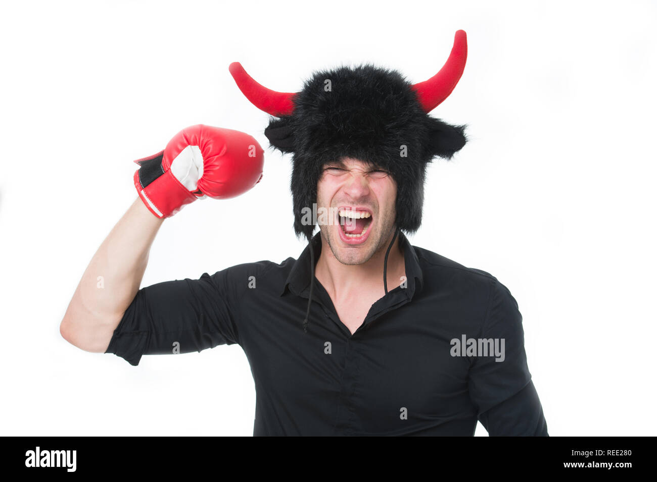 Angry as bull. Man shouting face wears hat of devil or bull with horns ...
