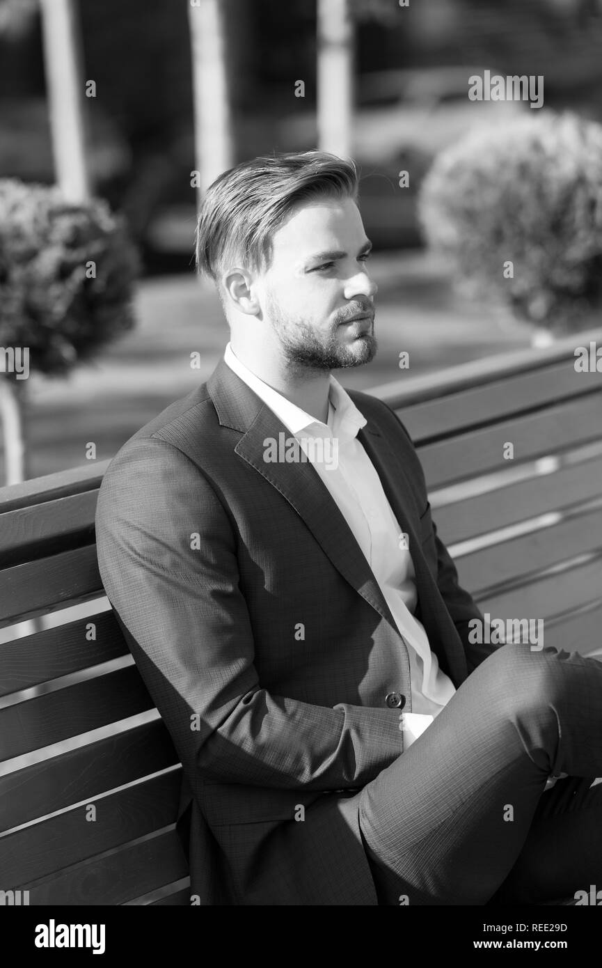 Manager man in business suit relax on bench in park. Business ...