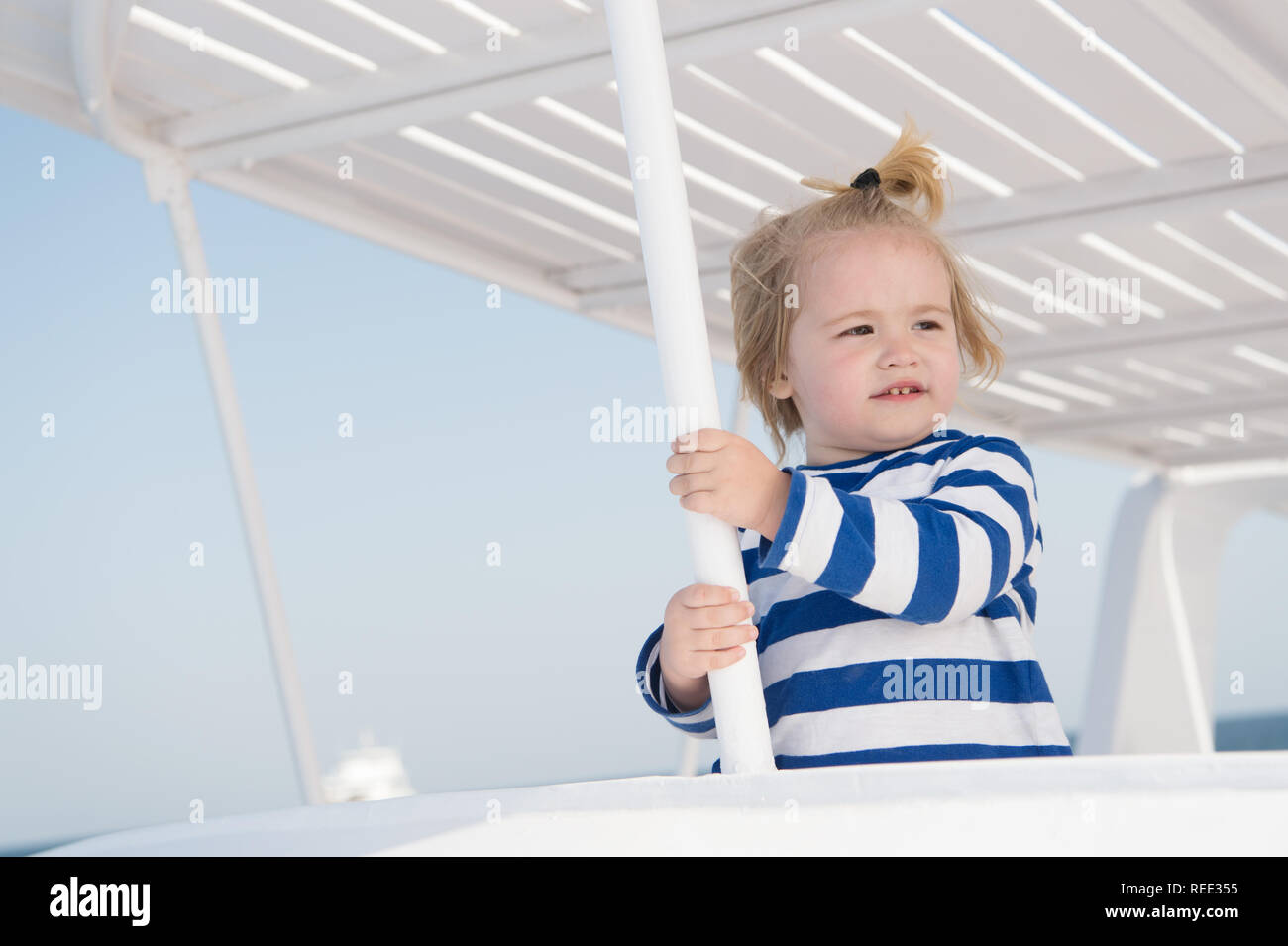 Cruising with kids. Child smiling face striped shirt looks like sailor ...