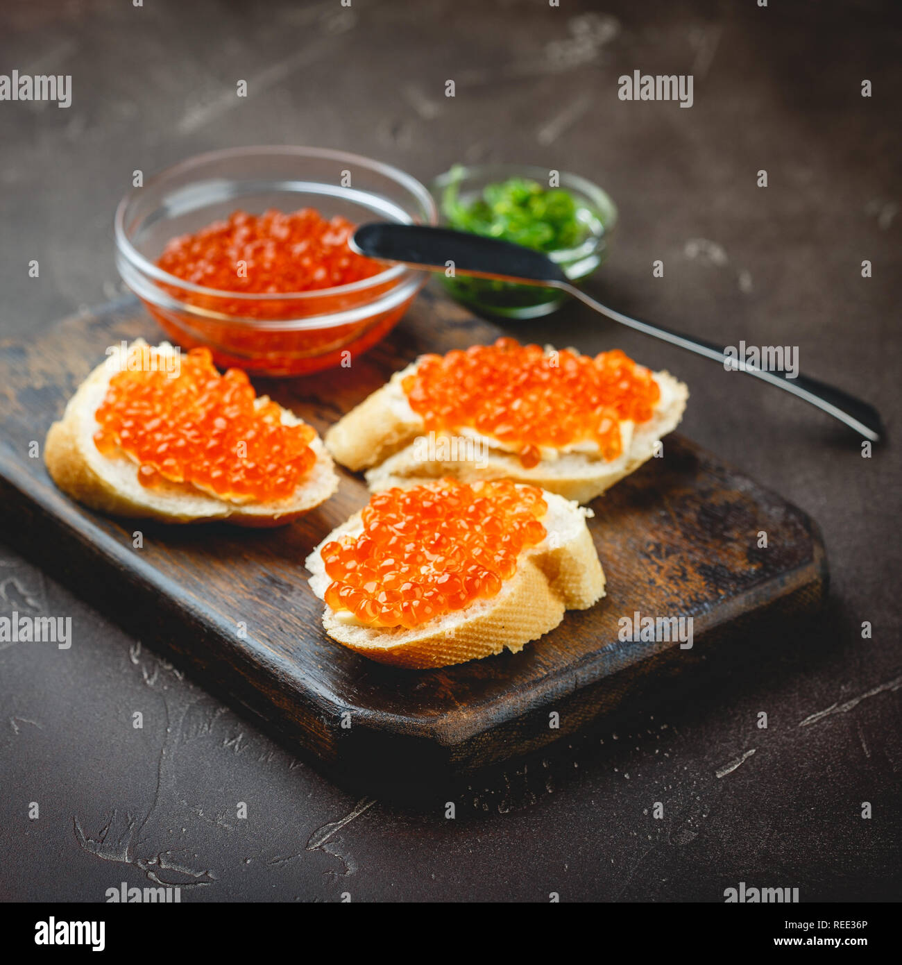 Delicious toasts with red caviar on the holiday table Stock Photo - Alamy