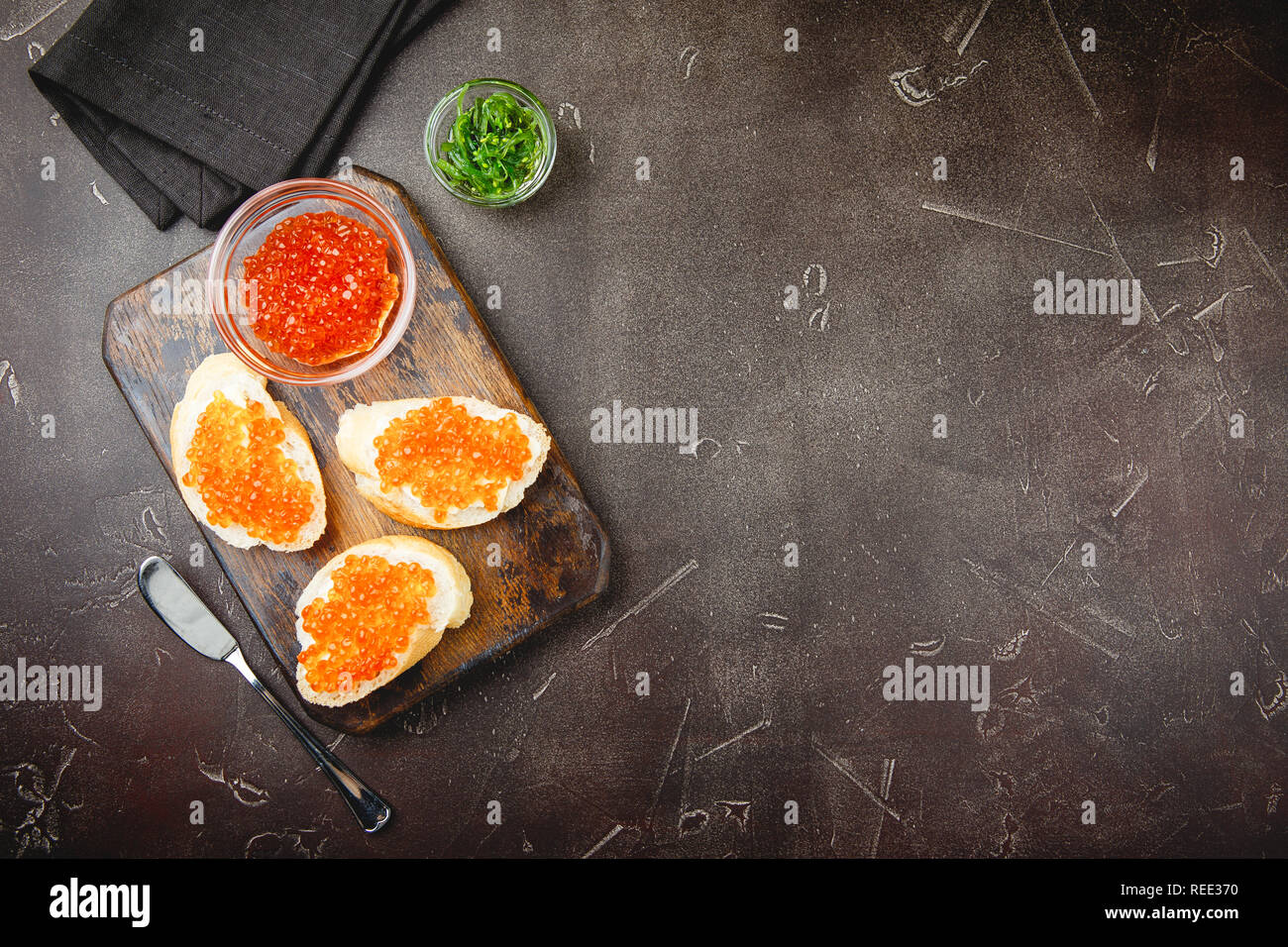 Delicious toasts with red caviar on the holiday table Stock Photo - Alamy