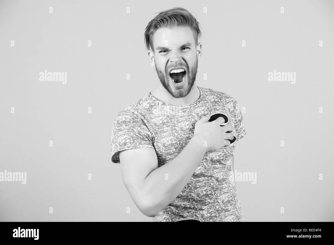 Macho with beard on angry face and stylish hair, haircut. Man in tshirt ...
