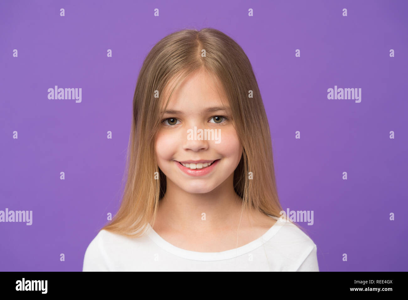 Beauty look and skincare. Little girl smile on violet background. Child ...