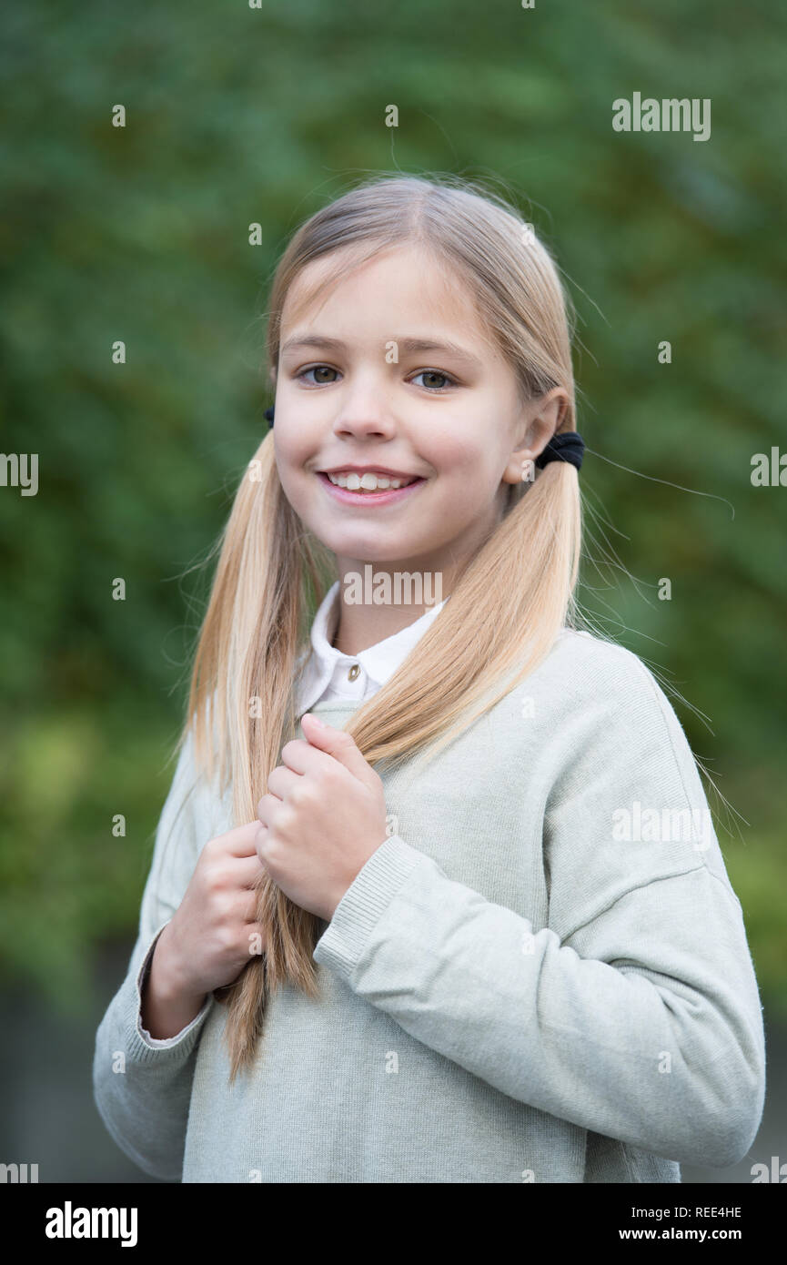 Hairstyle and hair care concept. Girl on smiling face posing with two ...