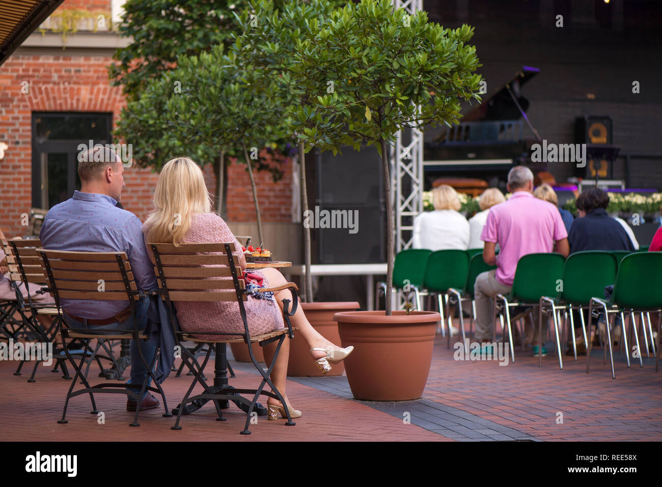 Married couple is sitting in restaurant, drinking wine, eating fancy ...