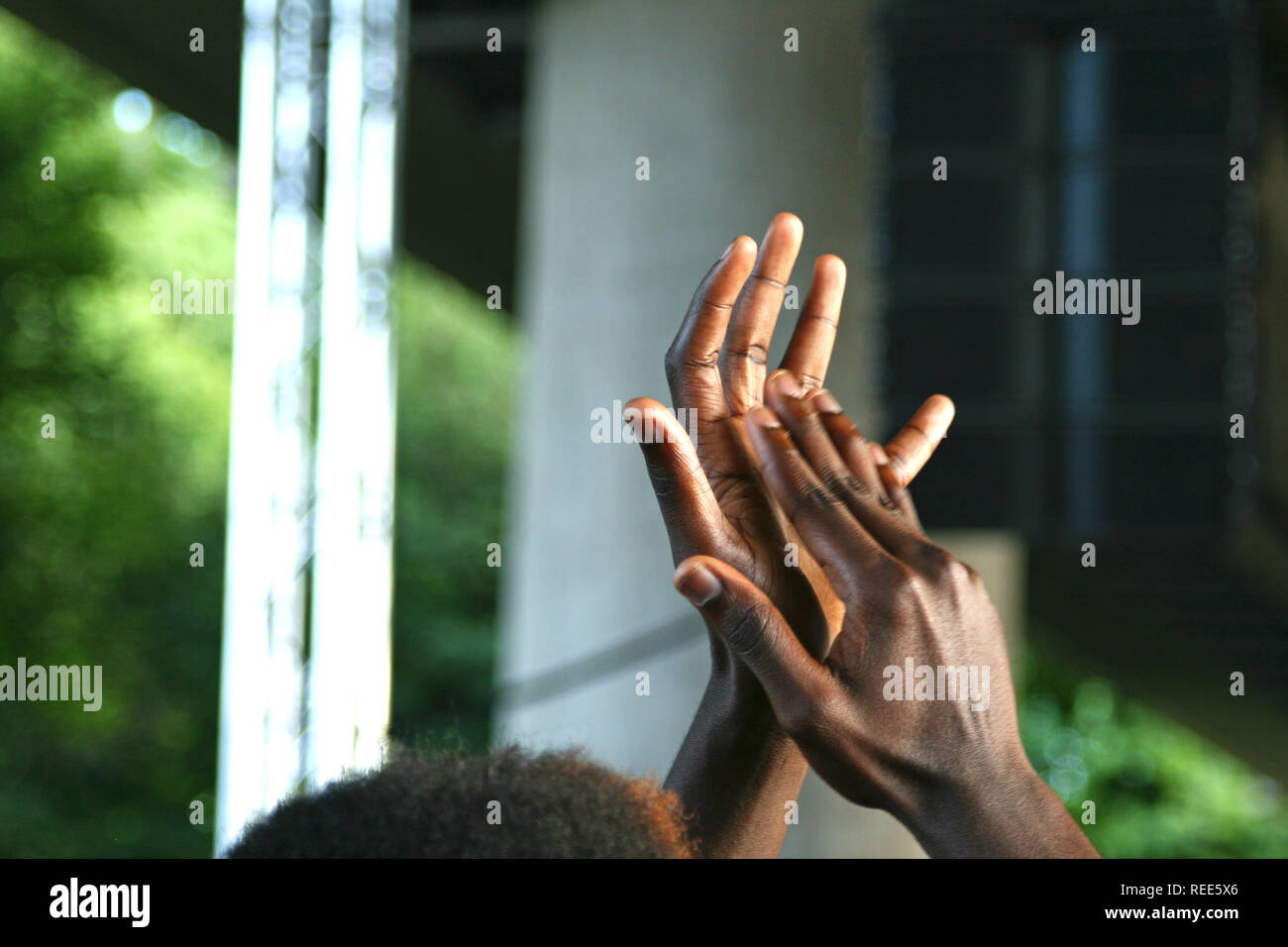 African man clapping hands at an open-air-concert Stock Photo - Alamy
