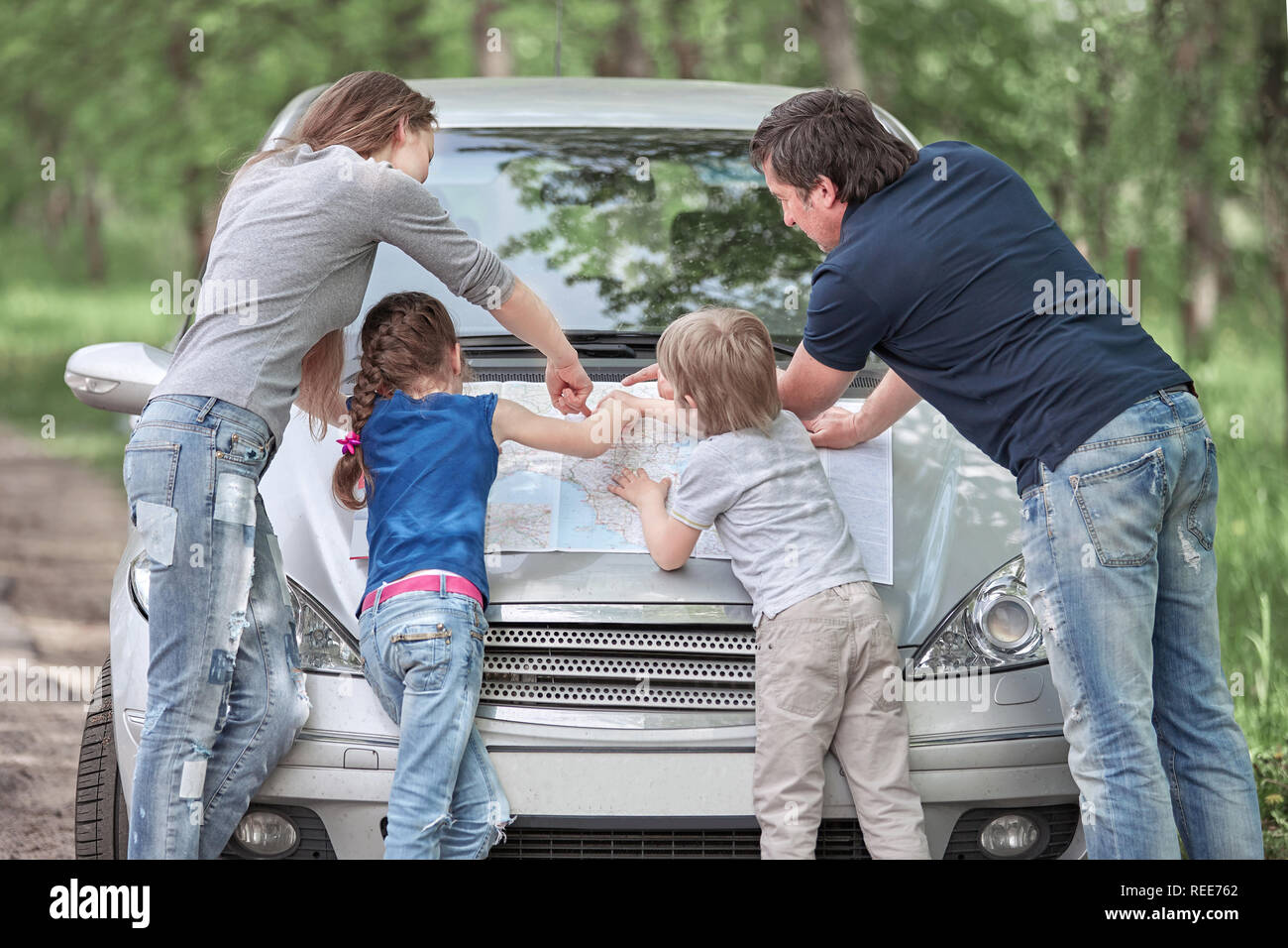 family with children standing near the faulty car Stock Photo - Alamy