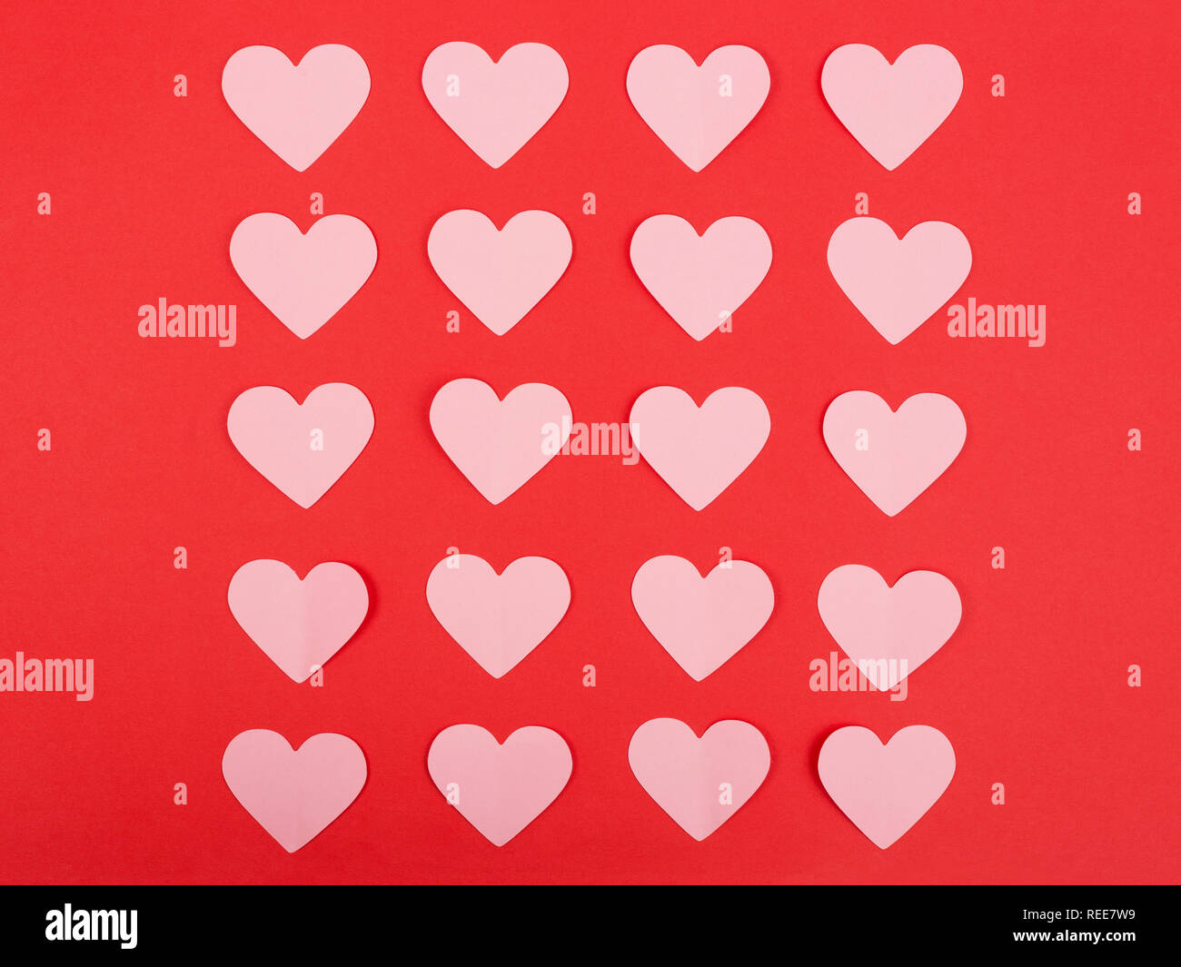 Pink paper hearts on red background Stock Photo - Alamy