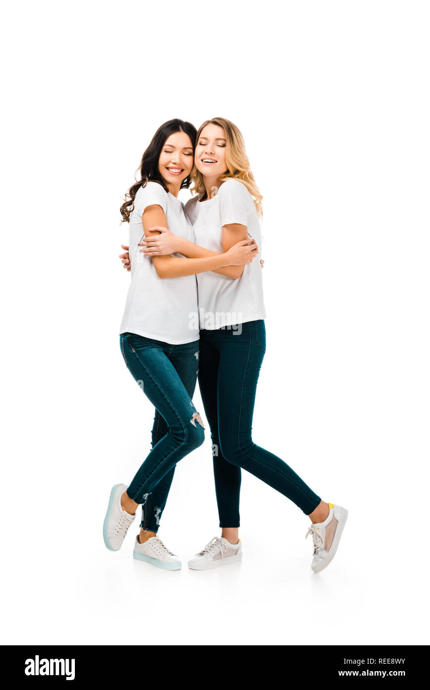 full length view of beautiful happy young women hugging isolated on ...