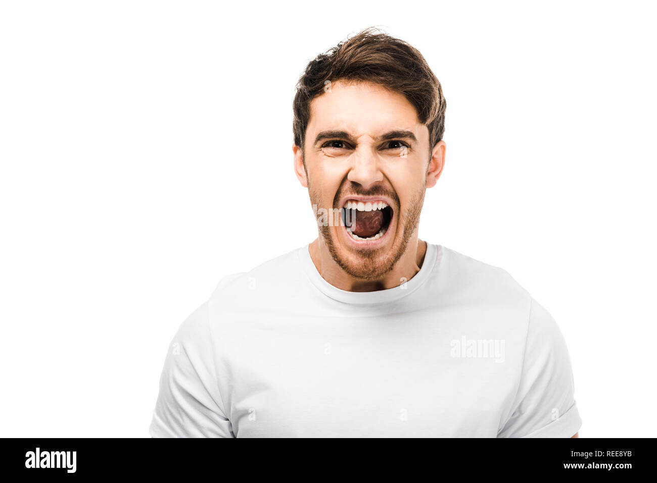 emotional young man screaming and looking at camera isolated on white ...