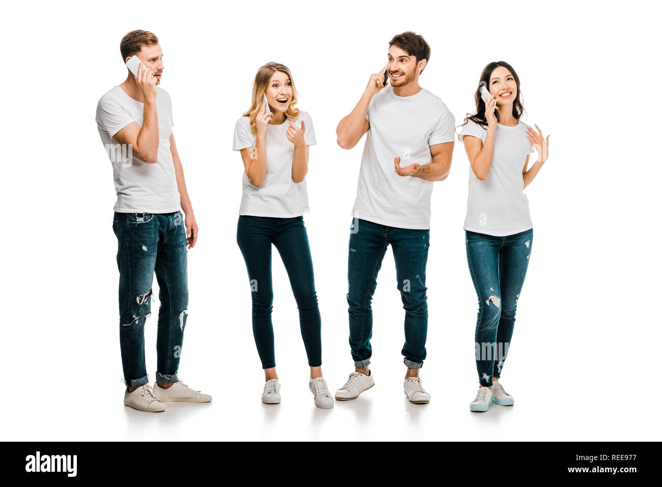 happy young friends standing together and talking by smartphones ...