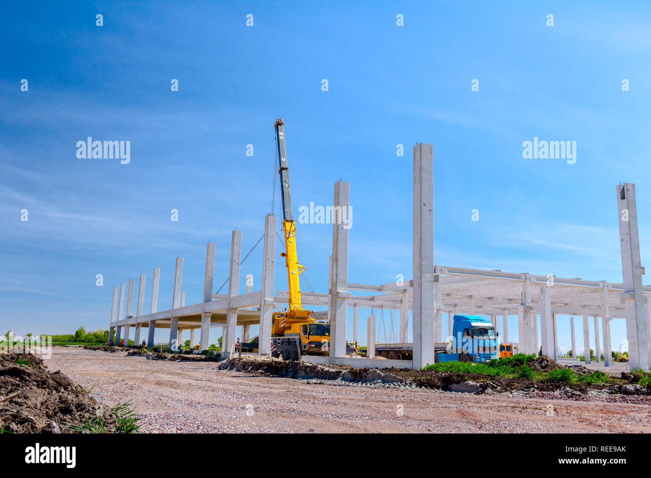 Mobile crane is assembly huge concrete skeleton of industrial building ...