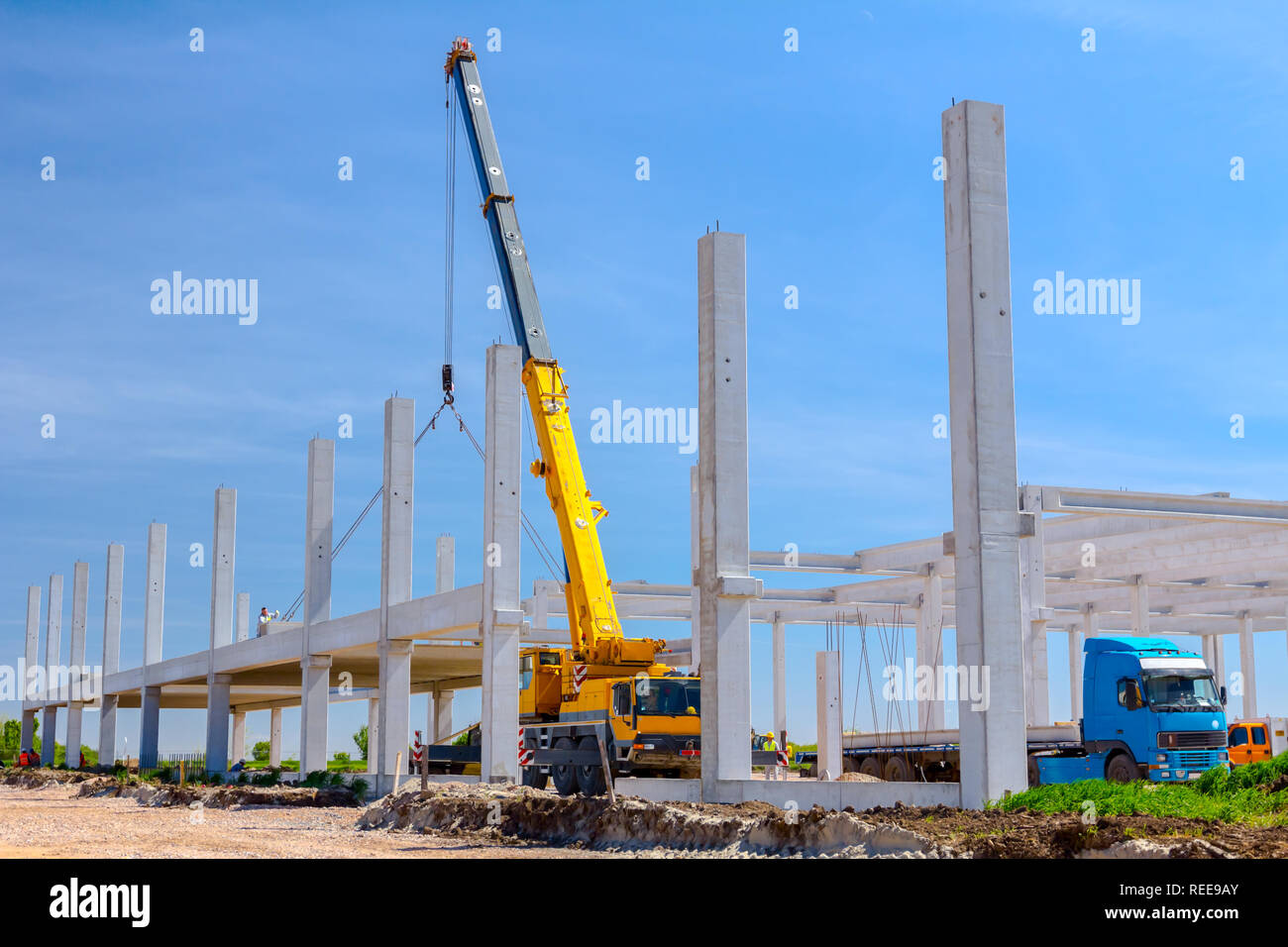 Mobile crane is assembly huge concrete skeleton of industrial building ...