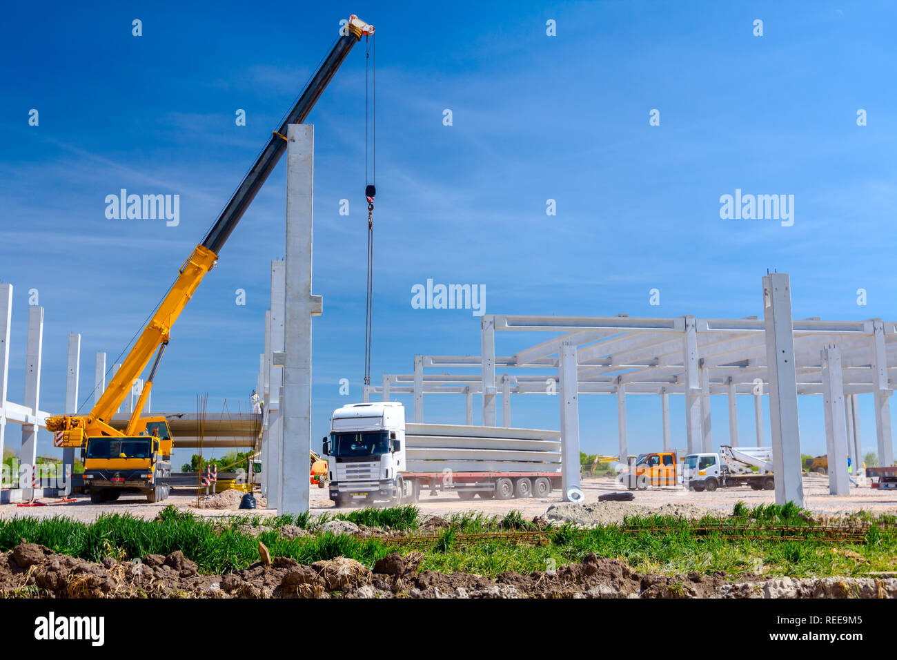 Mobile crane is assembly huge concrete skeleton of industrial building ...