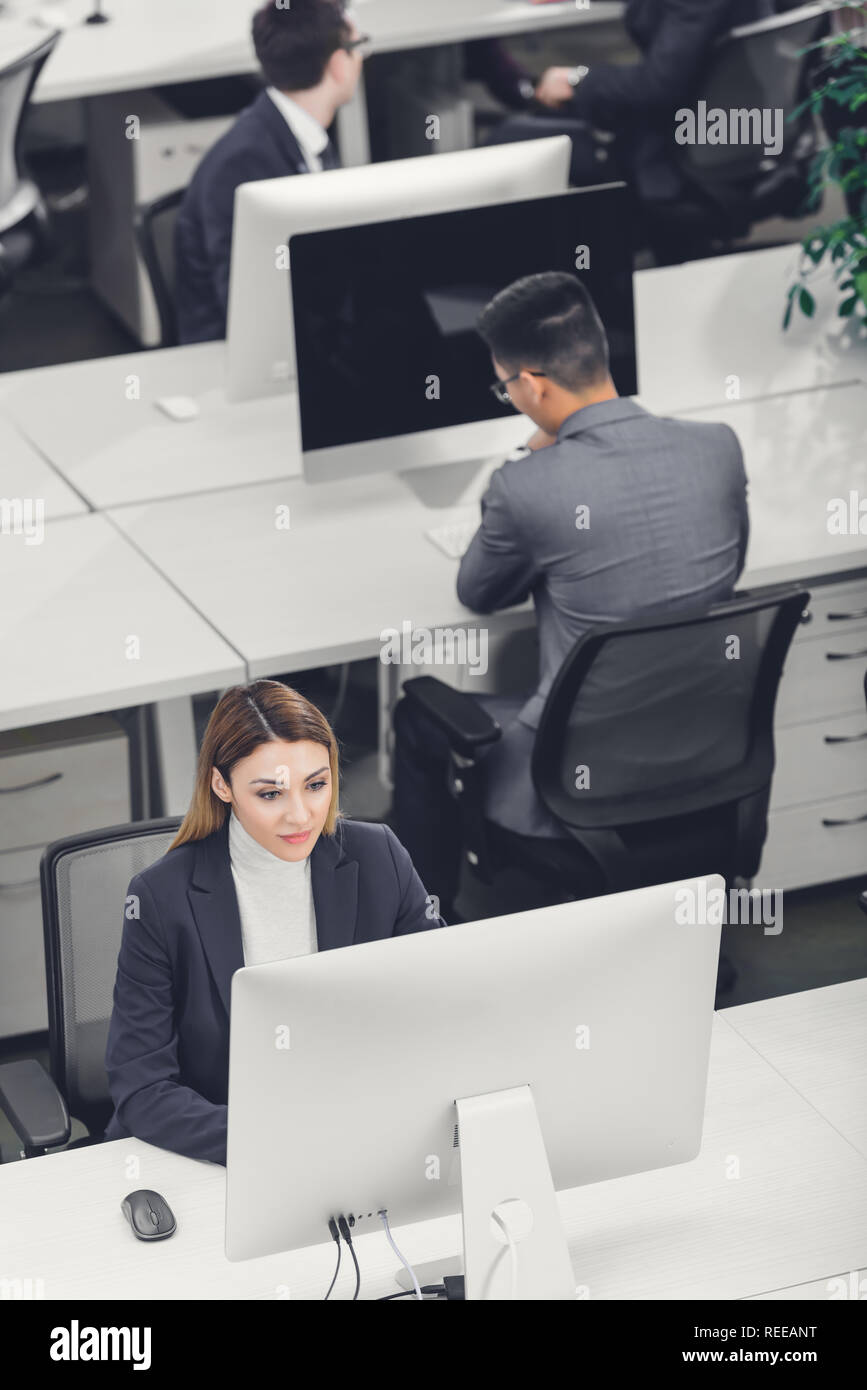 high angle view of male and female business people using desktop ...