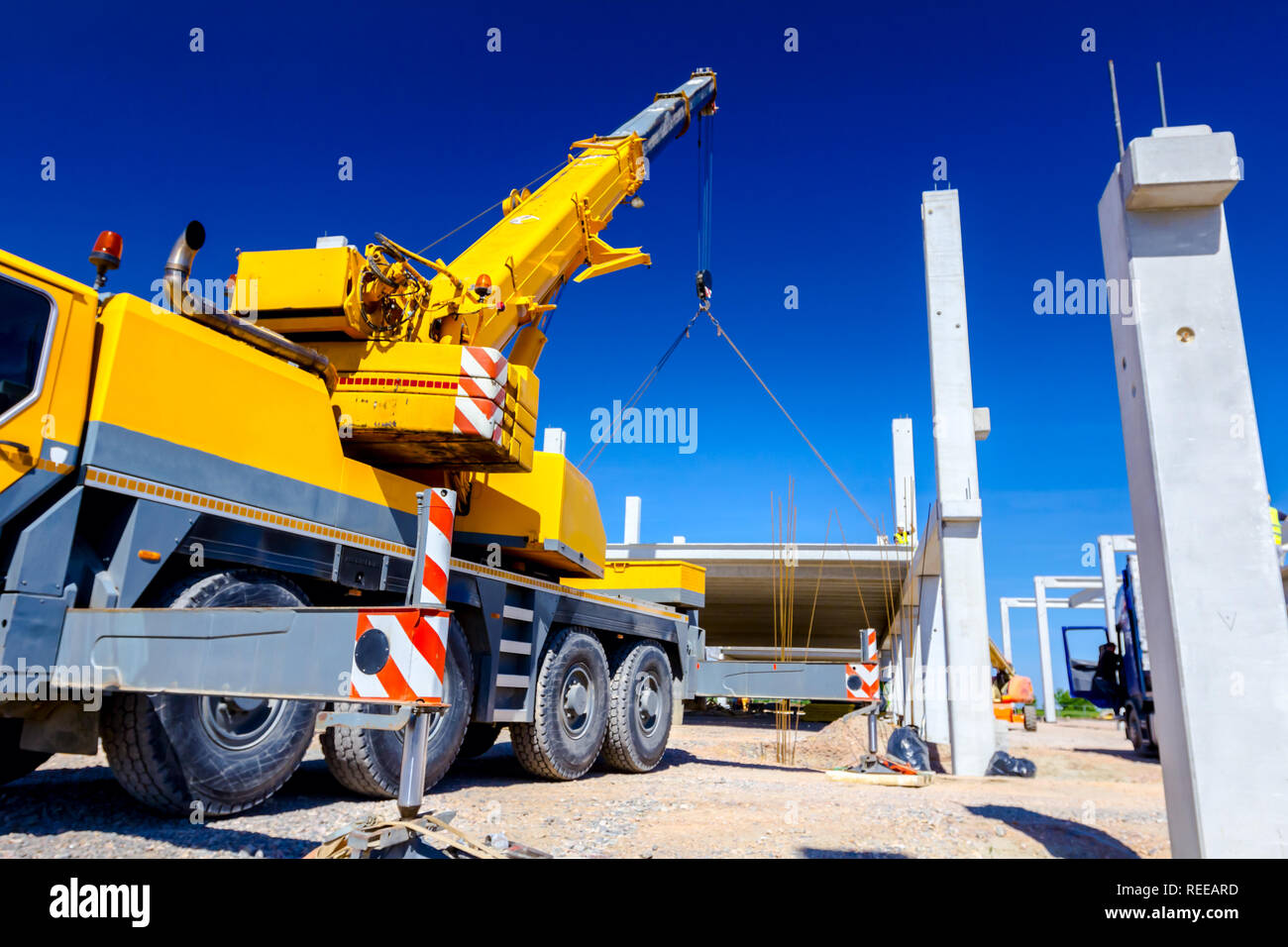 Low angle view on extended side hydraulic outrigger to increase crane ...