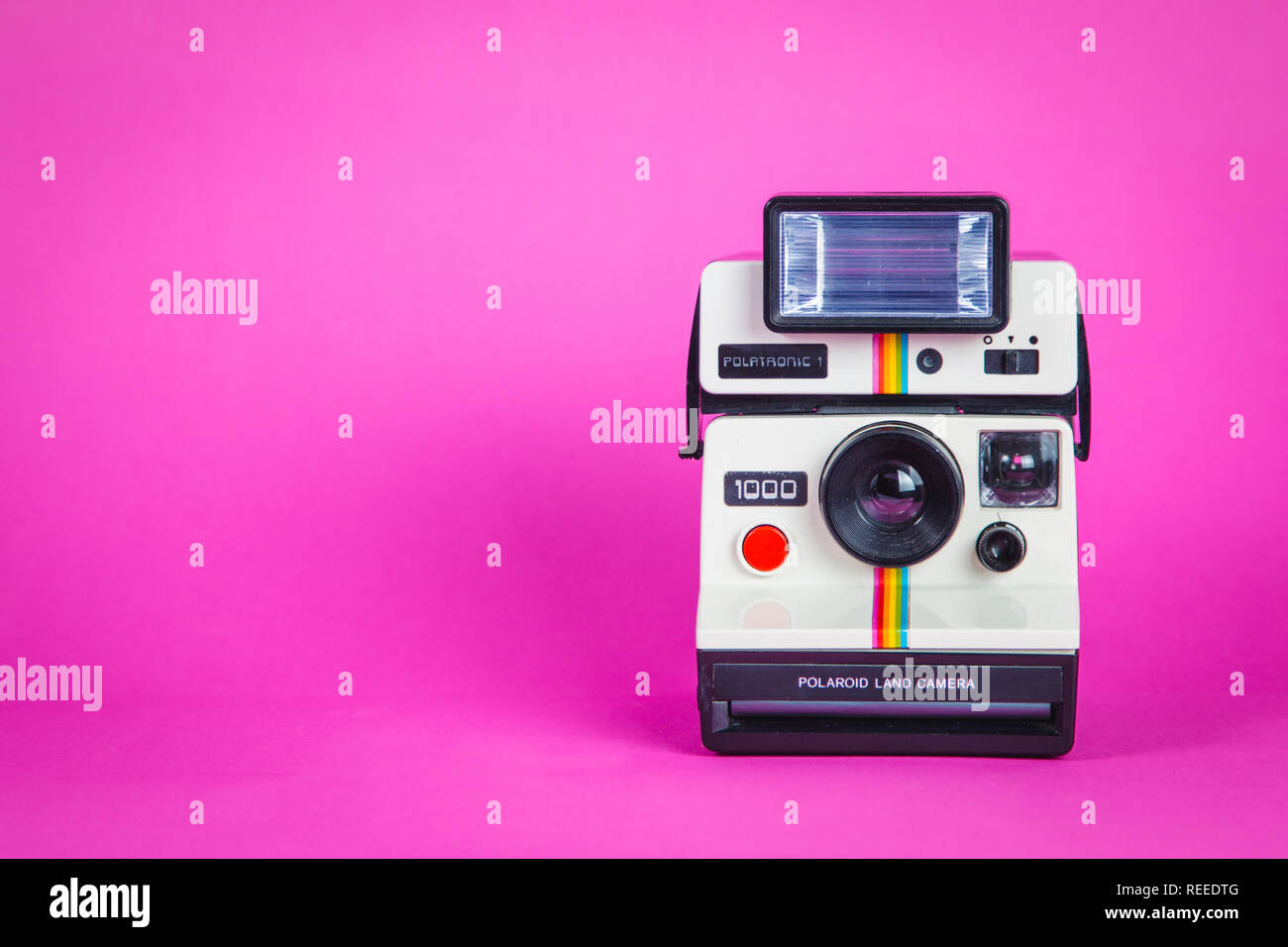 Polaroid photo camera on vibrant pink background Stock Photo - Alamy