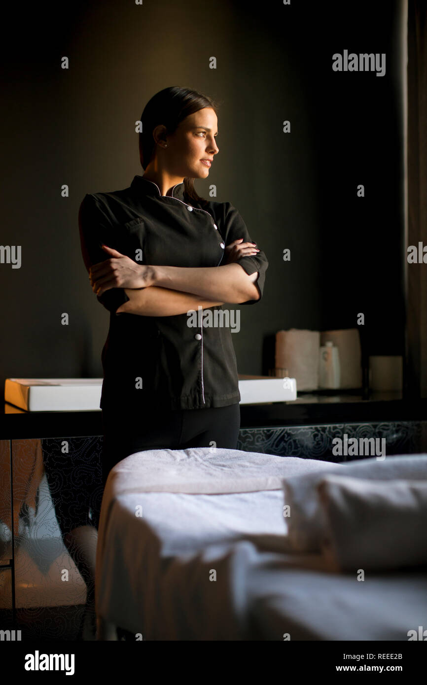 Pretty young therapist in the massage room Stock Photo - Alamy