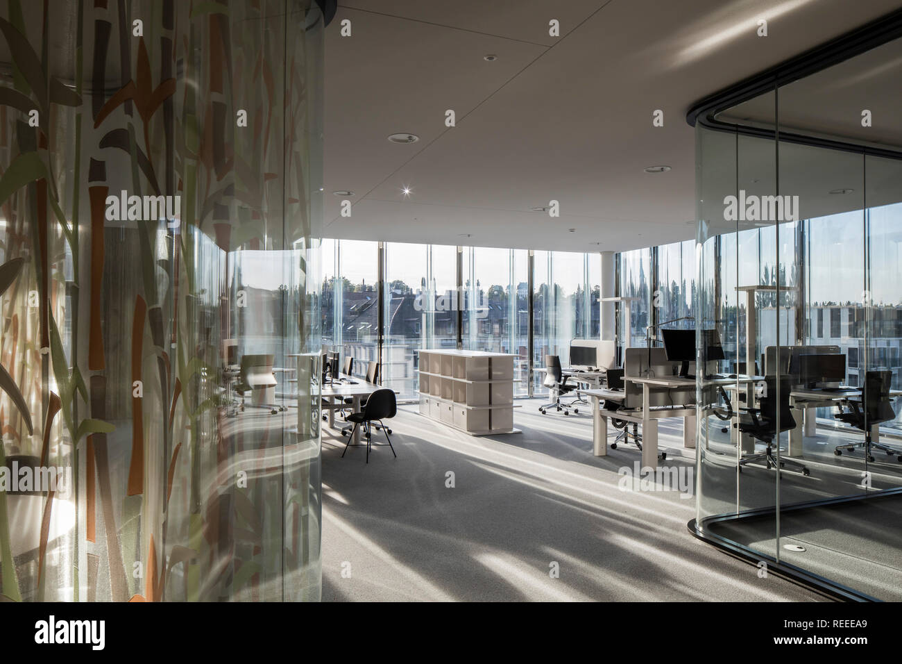 Office interior with incoming sunlight and glazed think tanks. Swiss Re ...