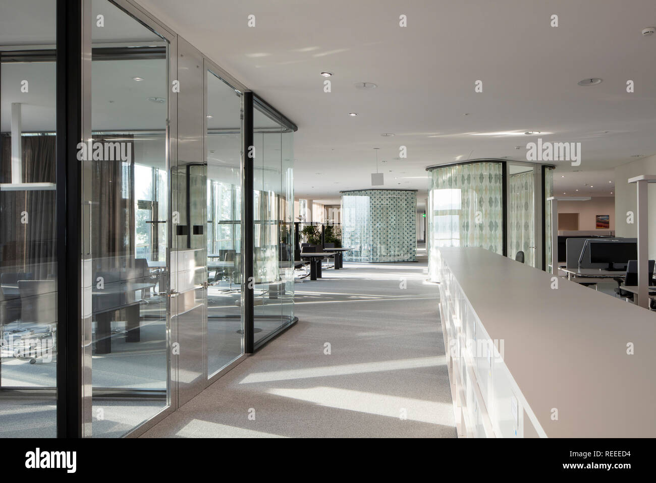 Open plan office with glazed think tanks and circulation space. Swiss ...