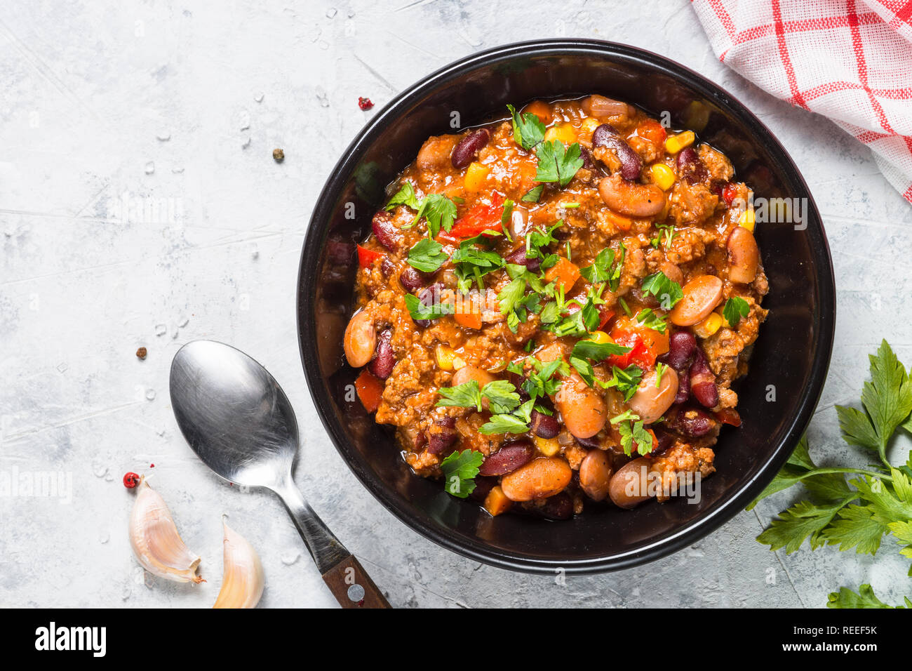 Chili con carne from meat, beans and vegetables in black plate on stone ...