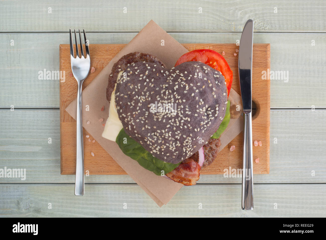 Heart shaped black hamburger, love burger fast food concept, Valentines ...