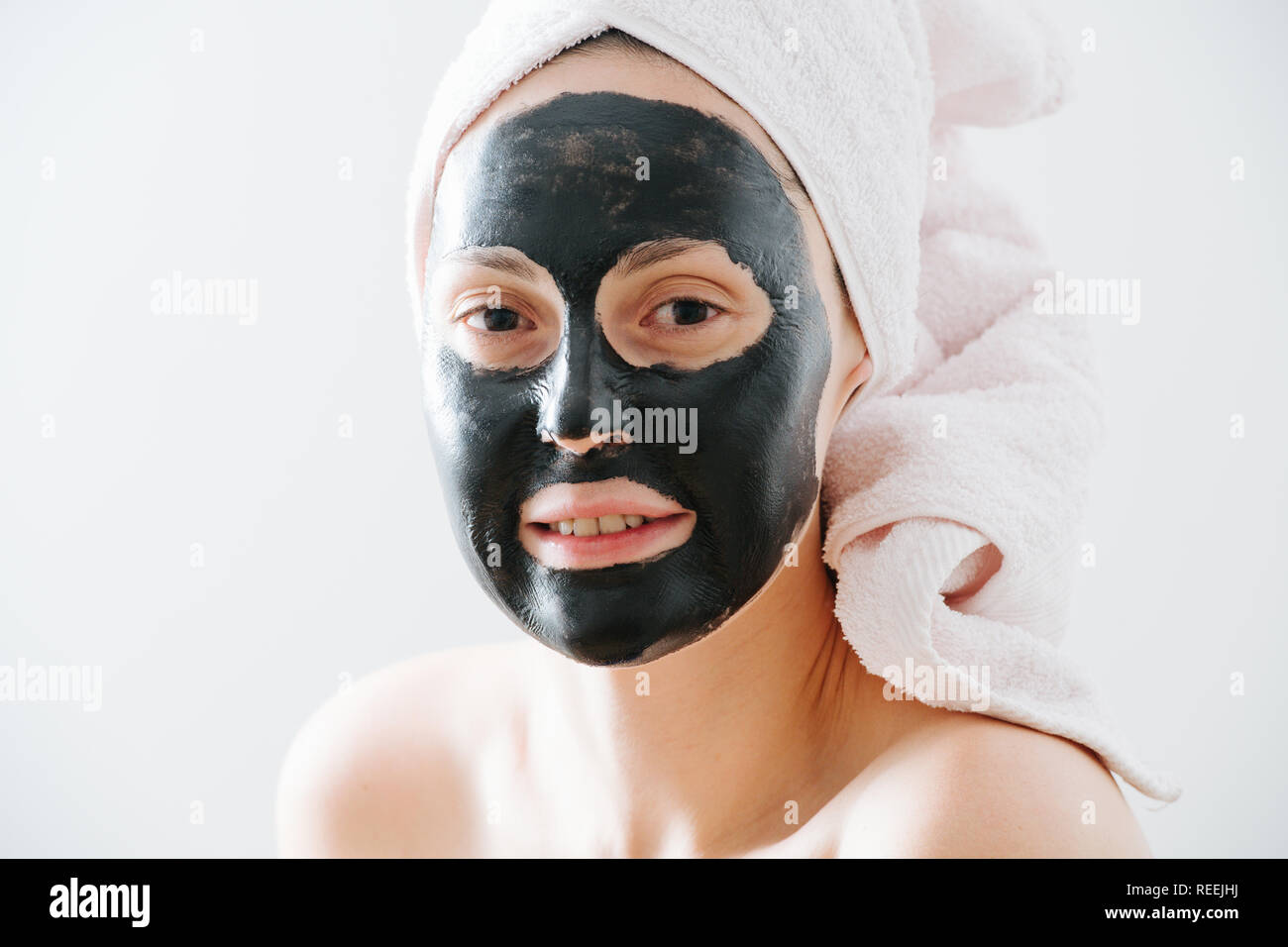 Young clean woman after shower with bamboo charcoal peel off facial ...