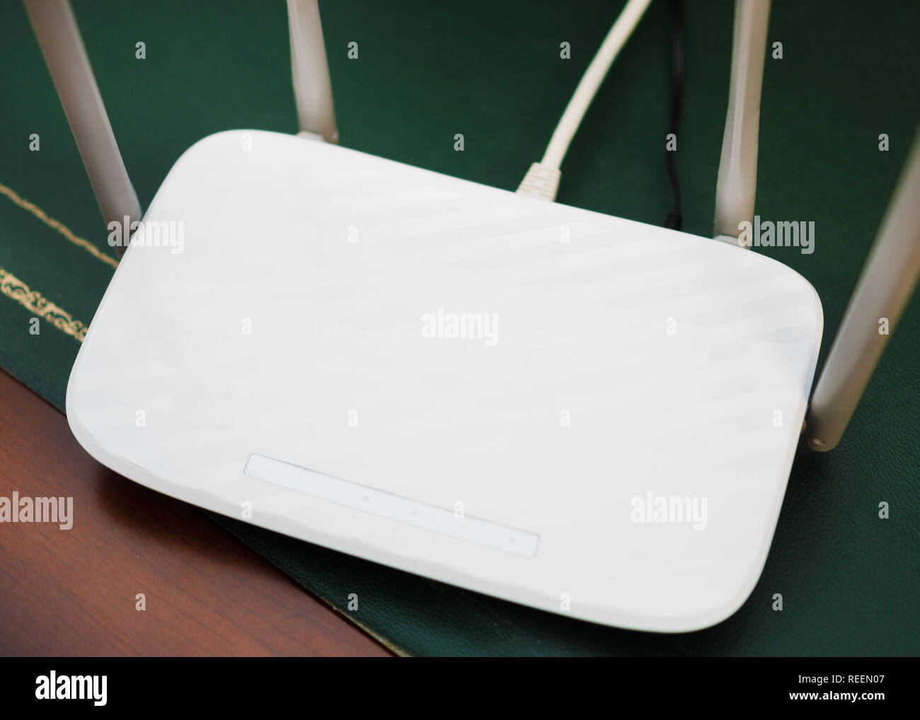 White wireless router standing on the table Stock Photo - Alamy