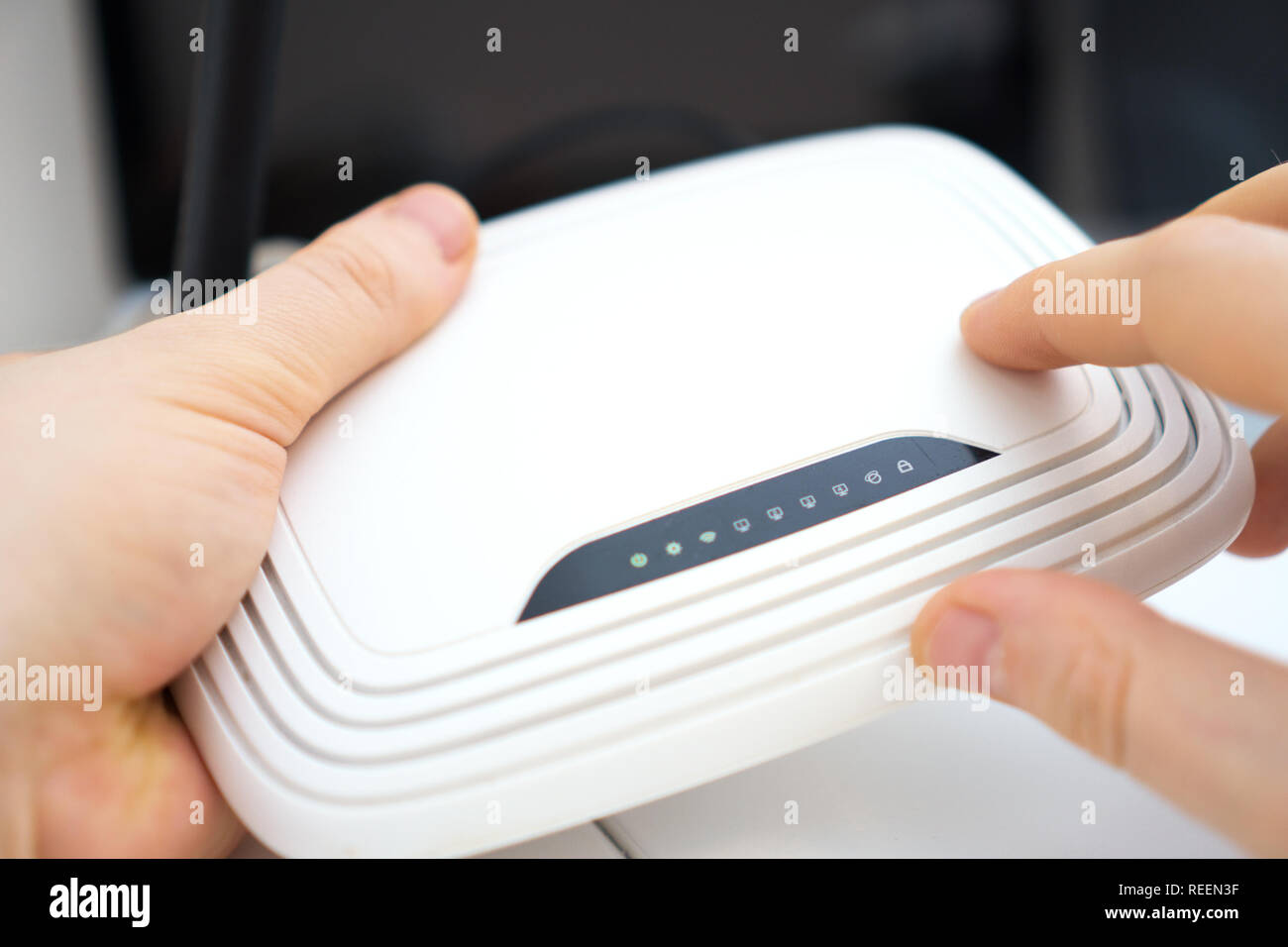Man holding white wireless router in his hands Stock Photo - Alamy