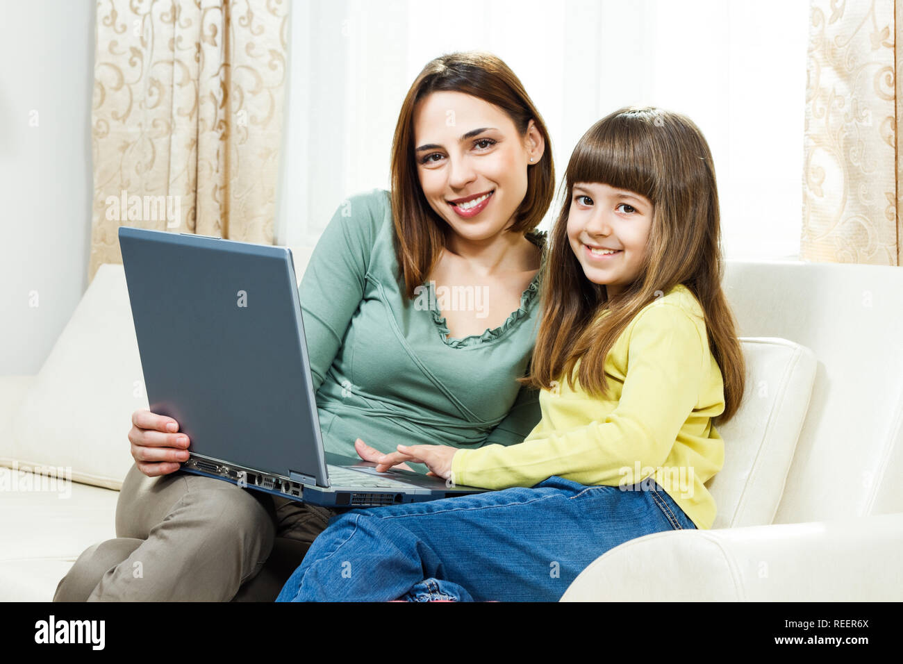 Mother and daughter using laptop Stock Photo - Alamy