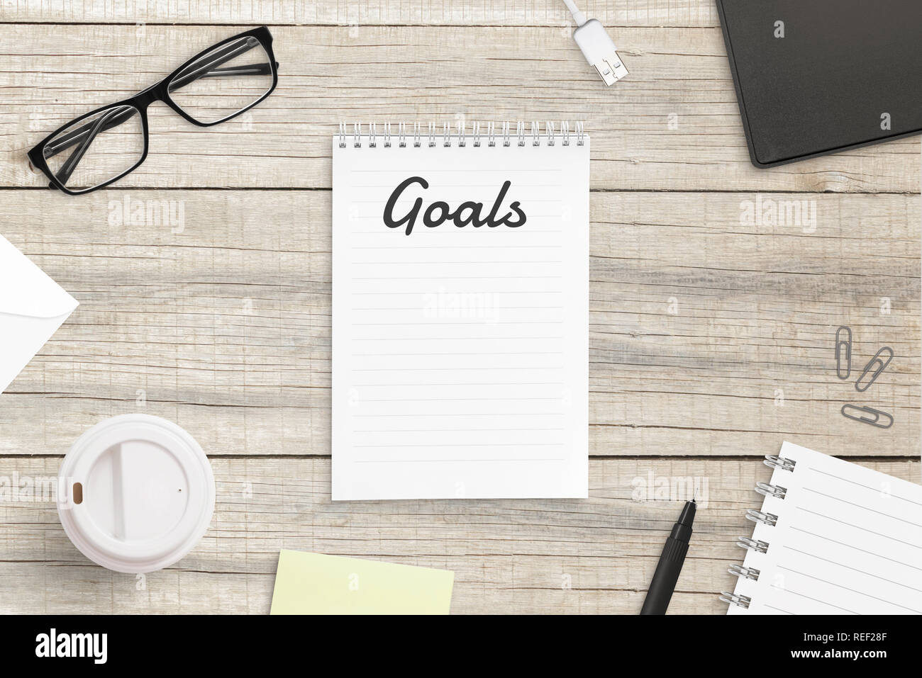 Notepad with goals text in header. Empty page for goals list. Top view ...