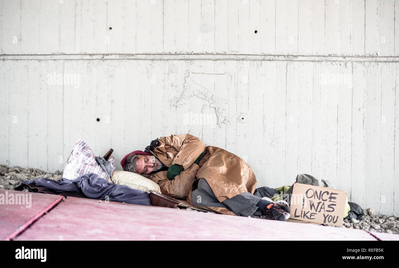 Homeless man lying street hi-res stock photography and images - Alamy