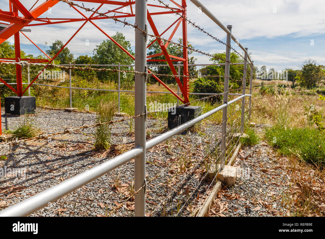 barbed wire fence around cell tower, close-up Stock Photo - Alamy