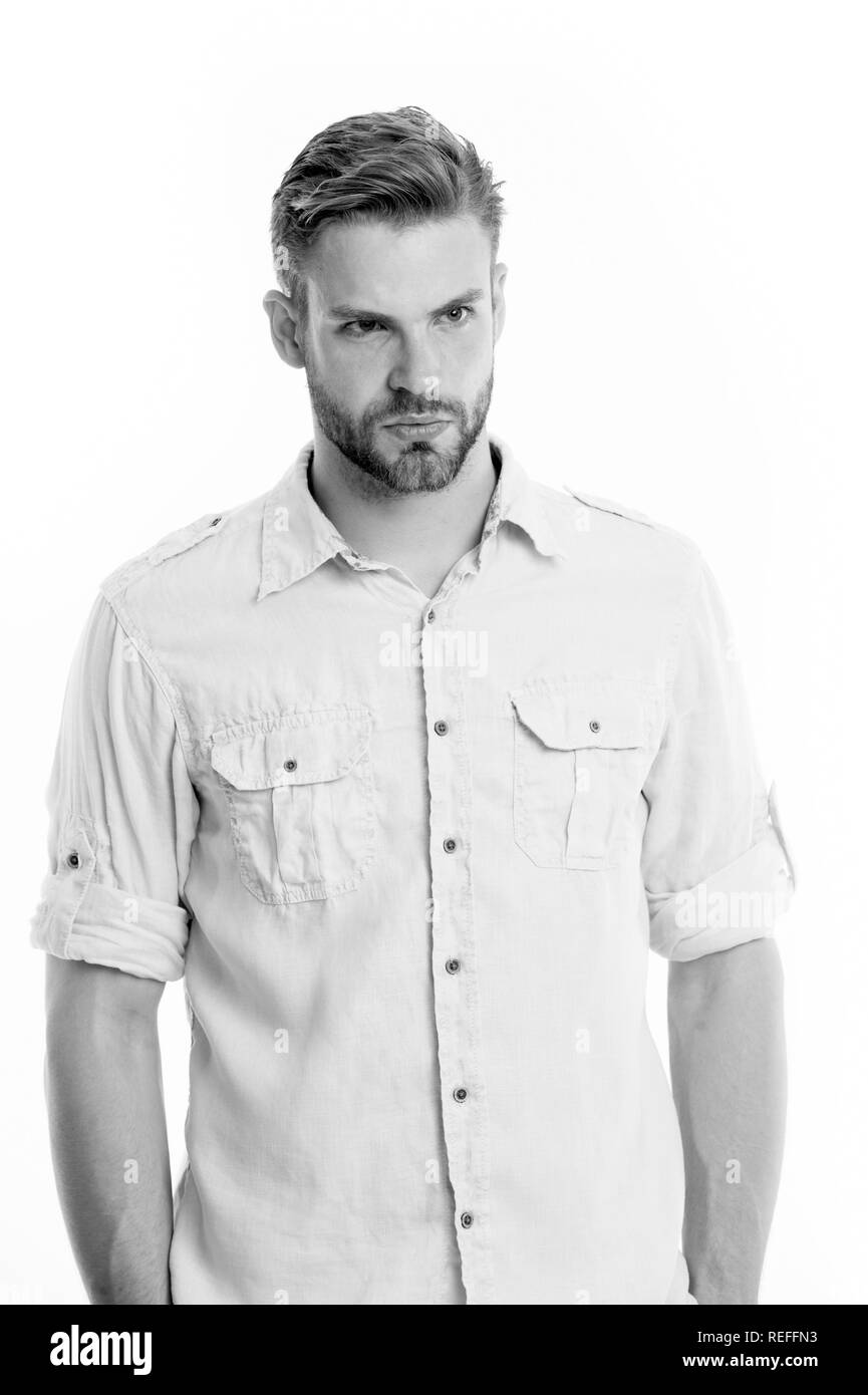 Man on calm face posing confidently with hands in pockets, white ...