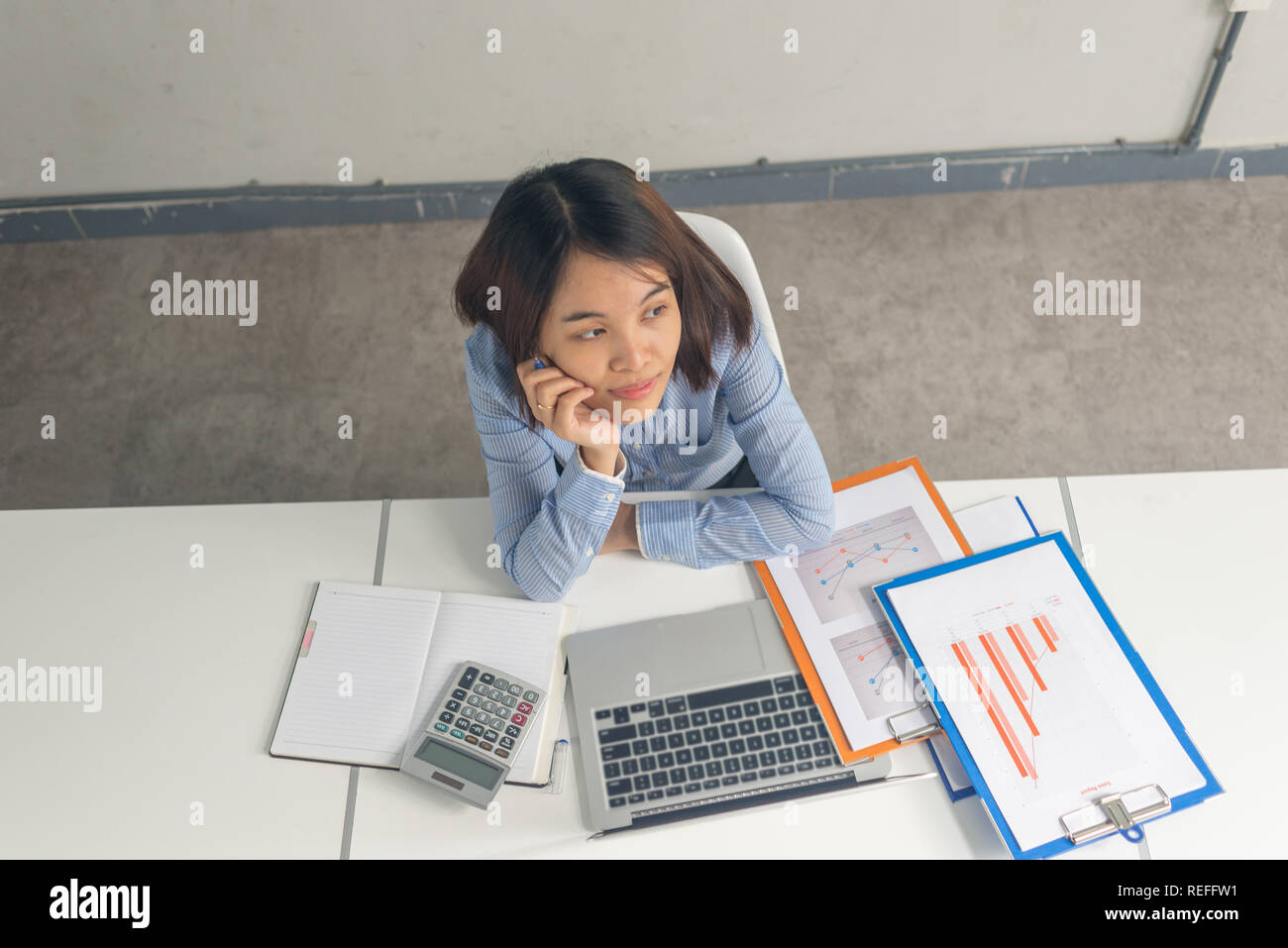 Young office woman thinking and working in the business office Stock ...