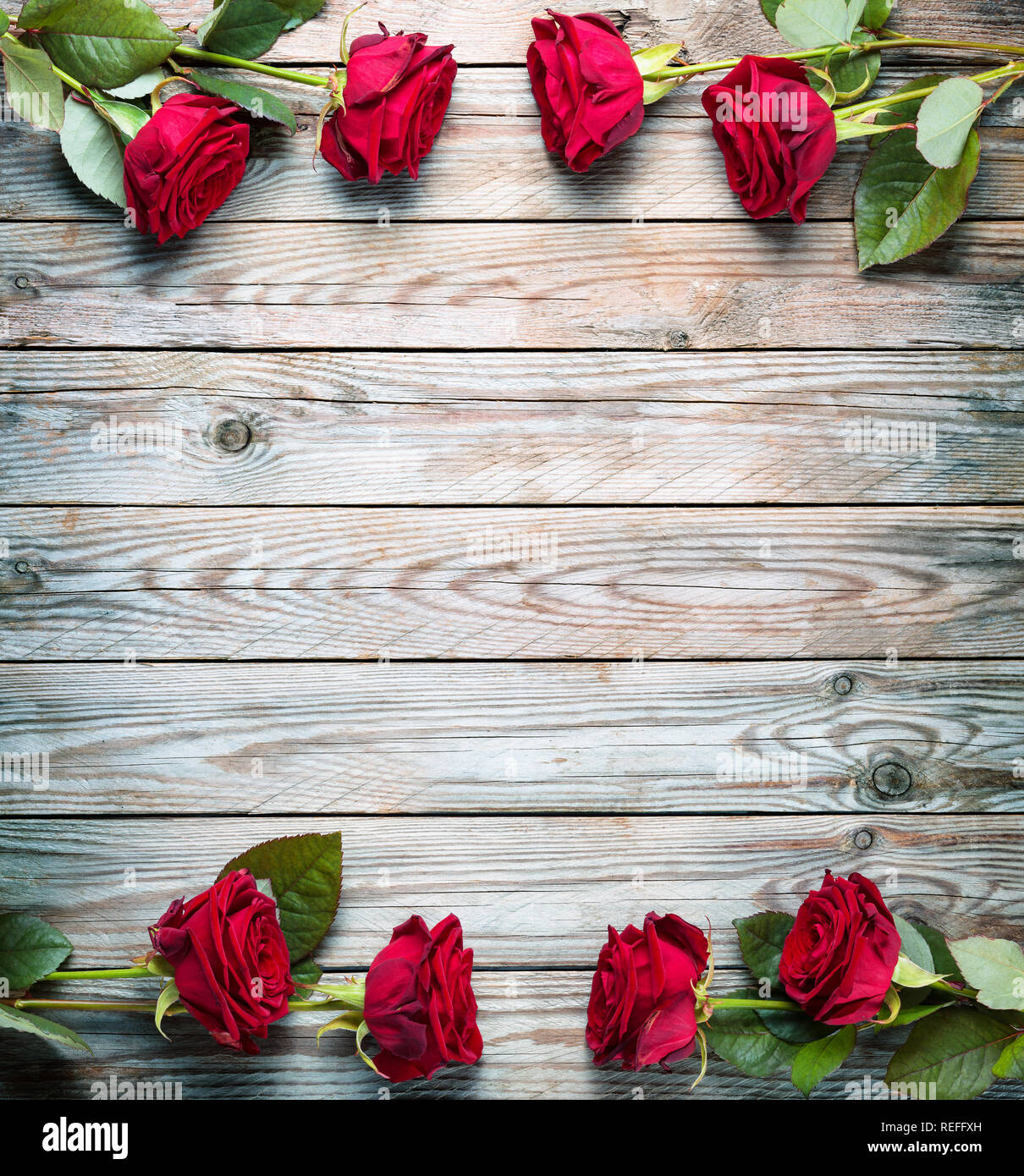 Frame of red roses on wooden rustic background Stock Photo - Alamy