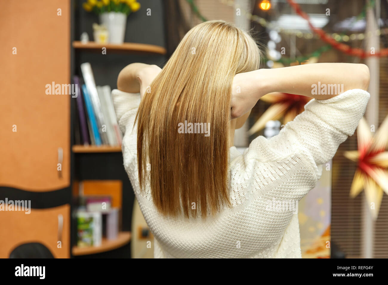 Professional hairdresser dyeing hair of her client in salon. Color hair ...