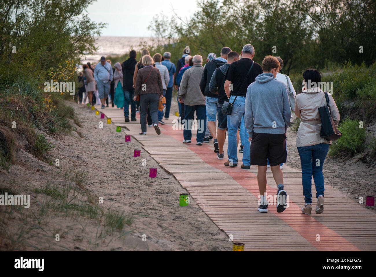 People are enjoying beautiful evening in park, walking on stairs ...