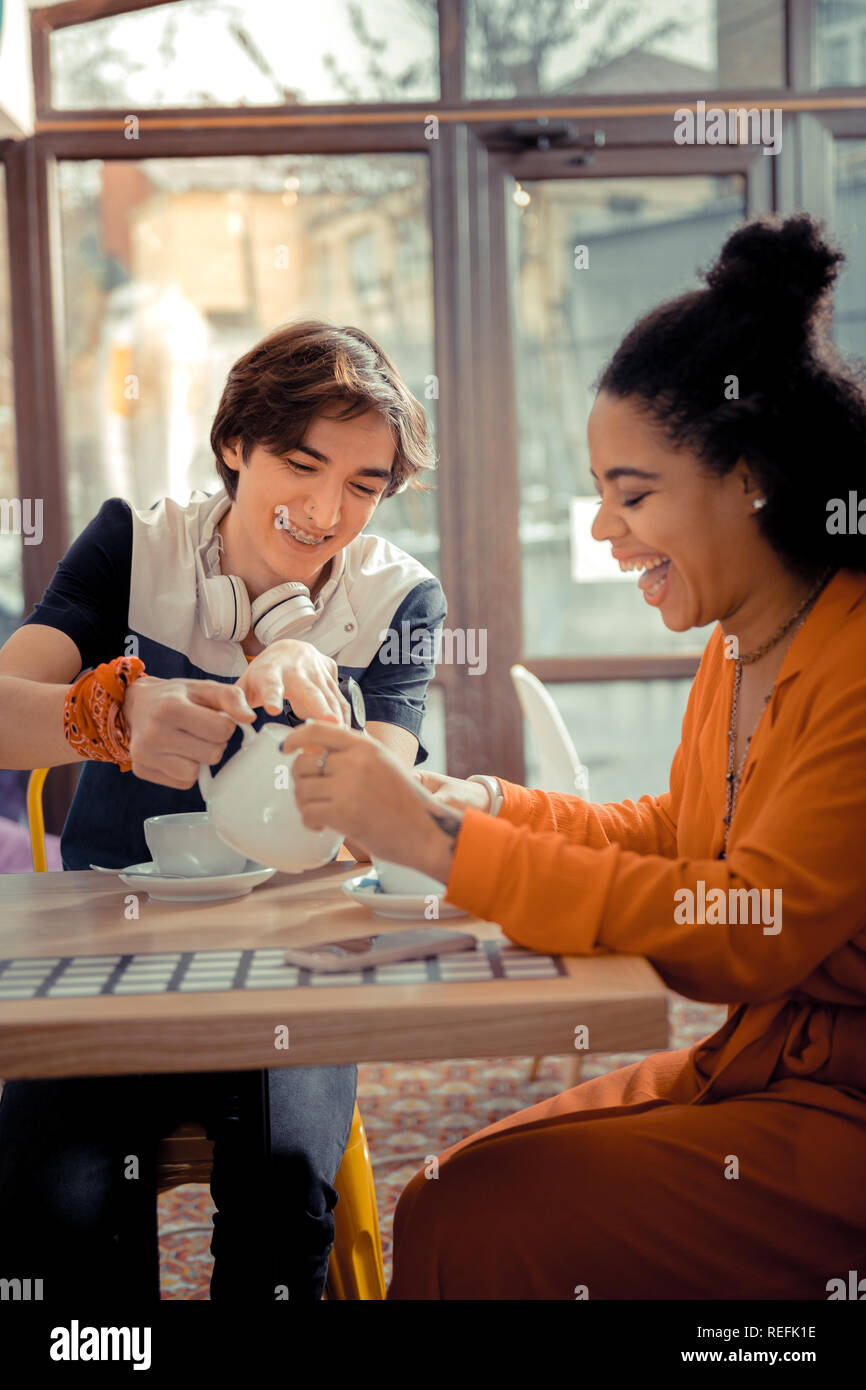Best friends laughing and drinking tea together Stock Photo - Alamy