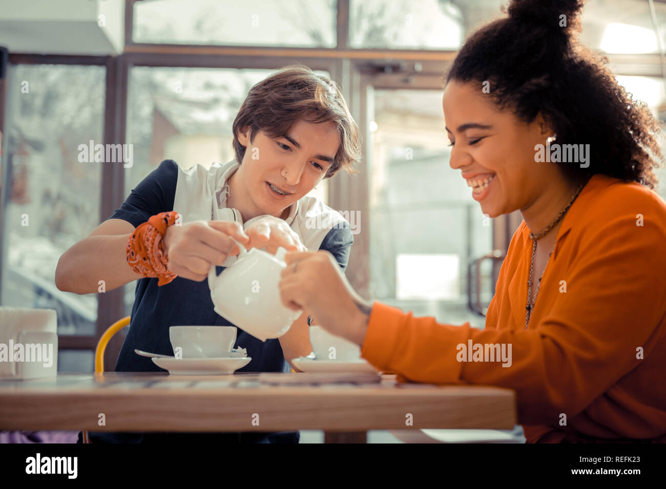 Boy and a girl drinking tea together Stock Photo - Alamy