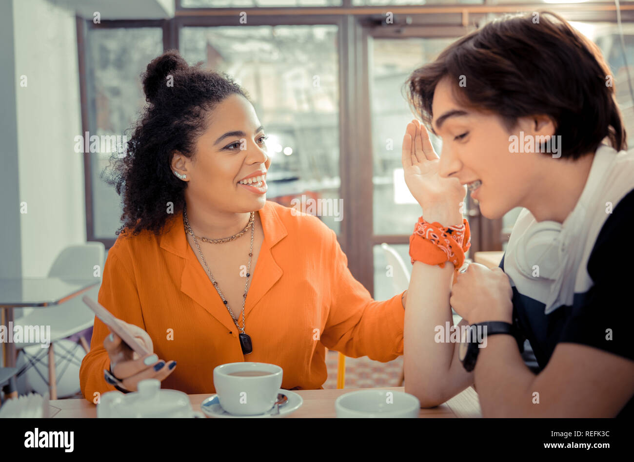 Friends planning trip together while sitting in a cafe Stock Photo - Alamy