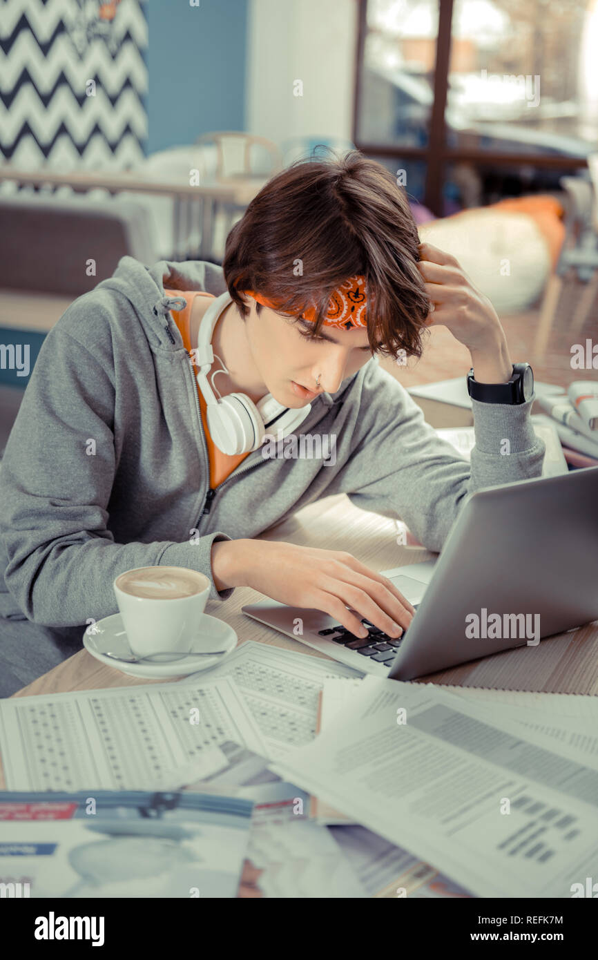 Student having difficulties with his course paper Stock Photo - Alamy