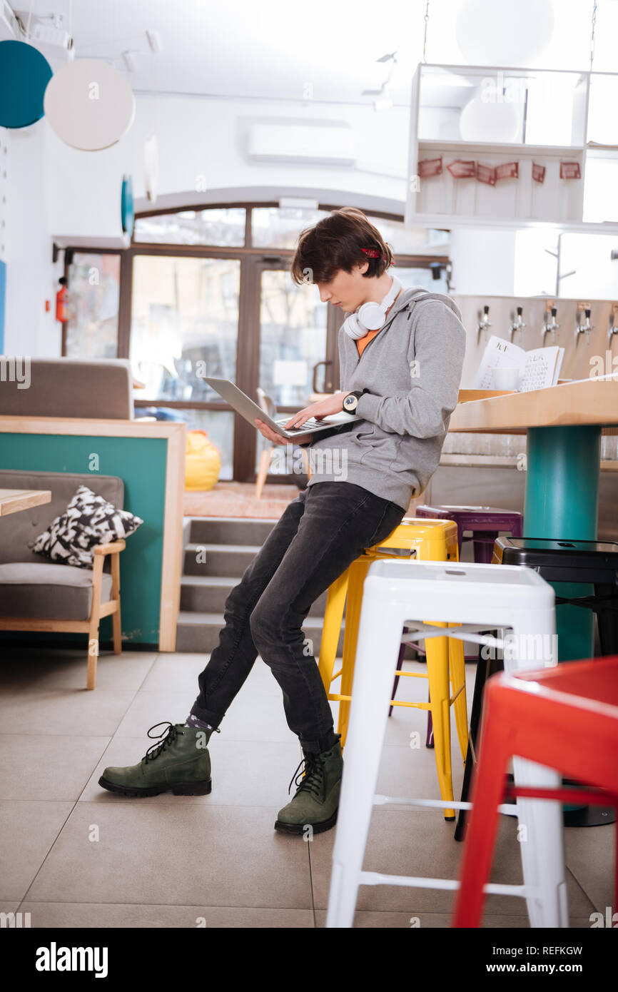 Teenager texting with his friends using laptop Stock Photo - Alamy