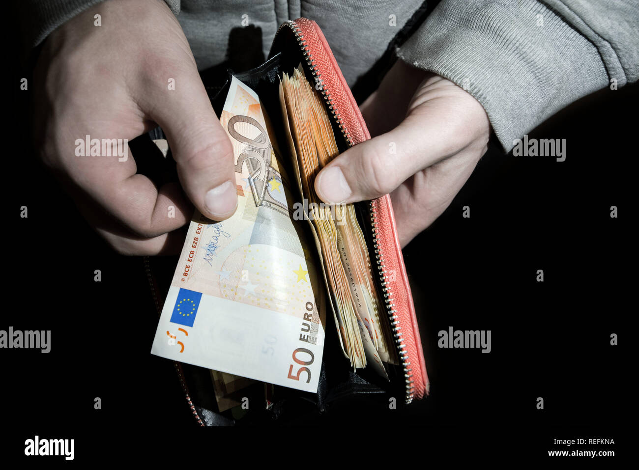 Man holding wallet full of euro money bills and banknotes. Concept of ...