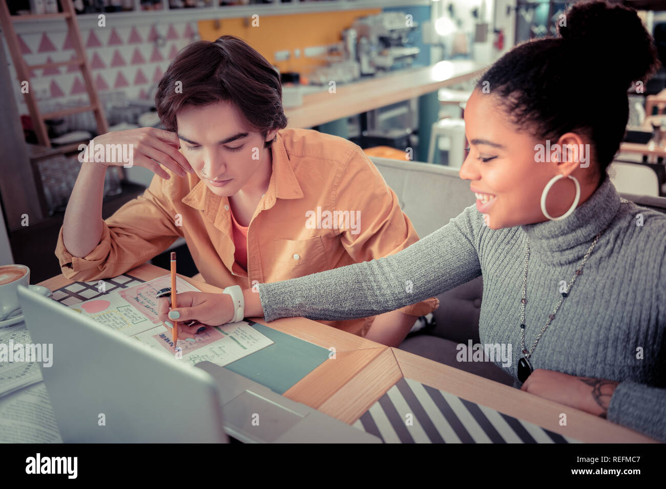 Student pointing on the mistake in other students work Stock Photo - Alamy