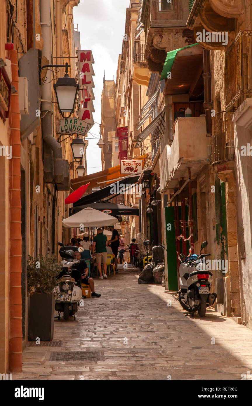 A view up Strait Street. It is a typical narrow side street of shops ...