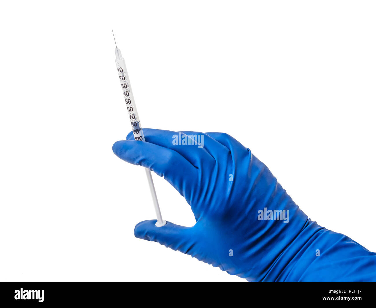 Doctor's hand in blue medical glove holding open syringe with medical ...